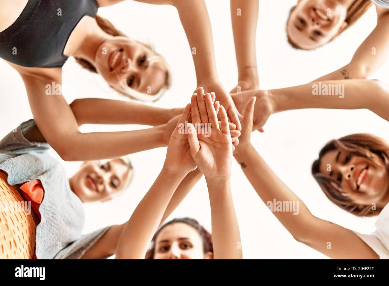 Group of young sporty girls with hands together Stock Photo - Alamy