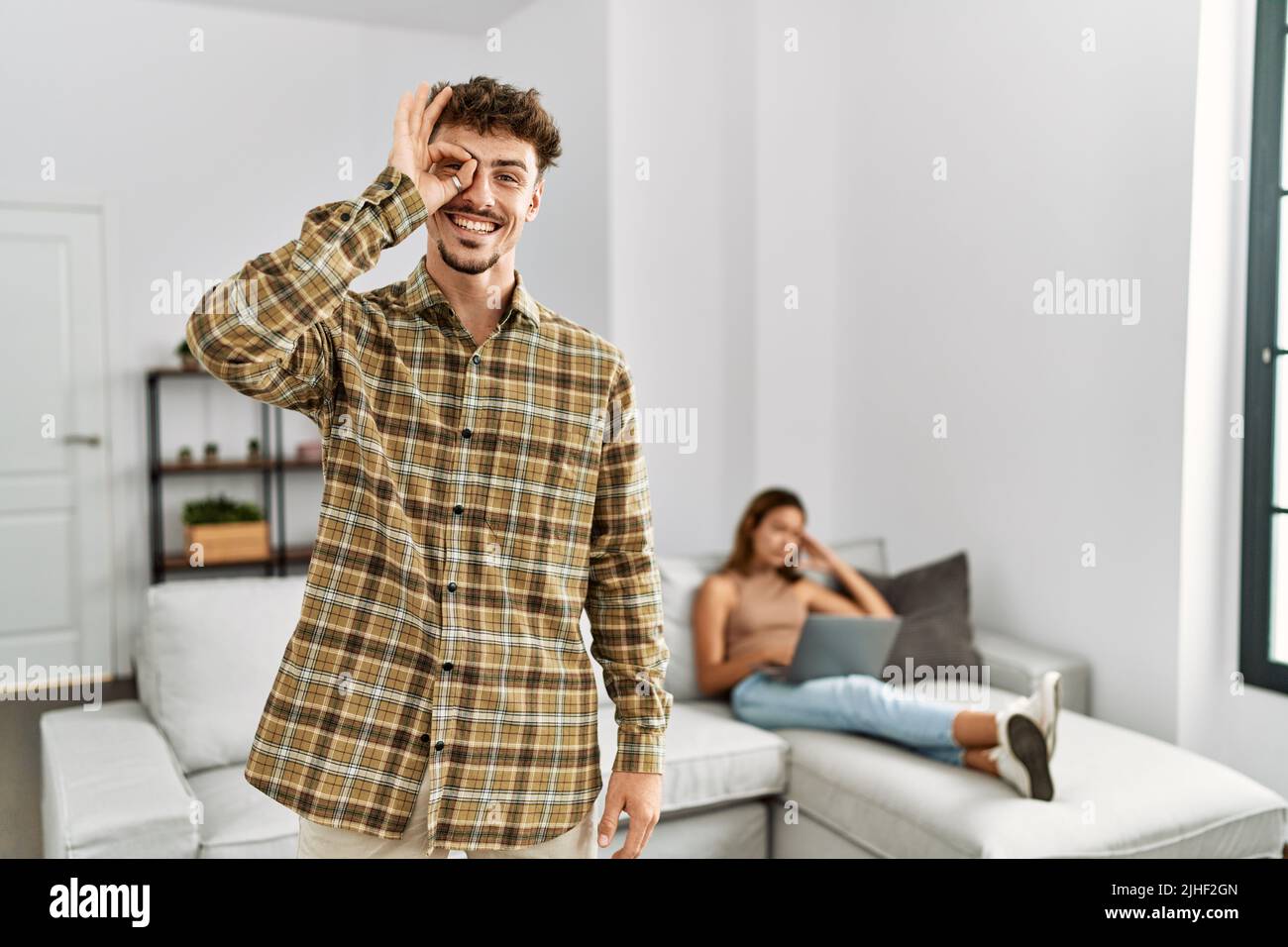 Young handsome man at the living room with girlfriend smiling happy ...