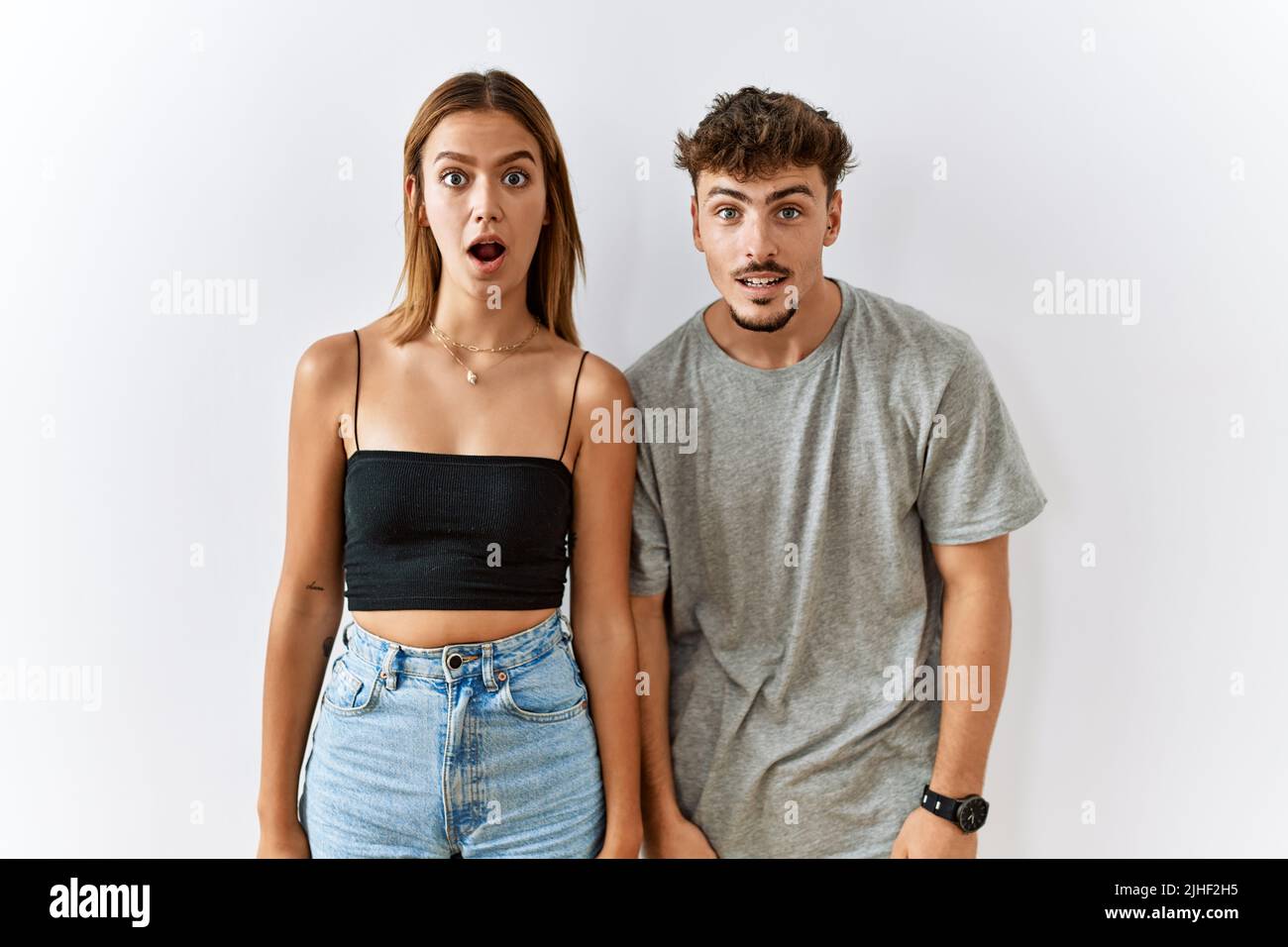Young beautiful couple standing together over isolated background ...