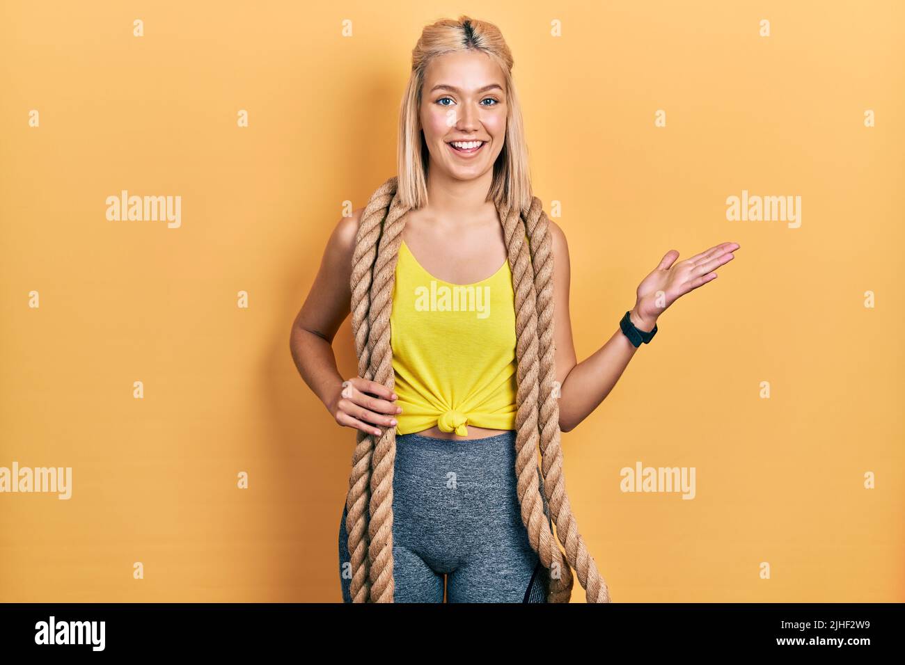 Beautiful blonde woman training with battle rope celebrating ...
