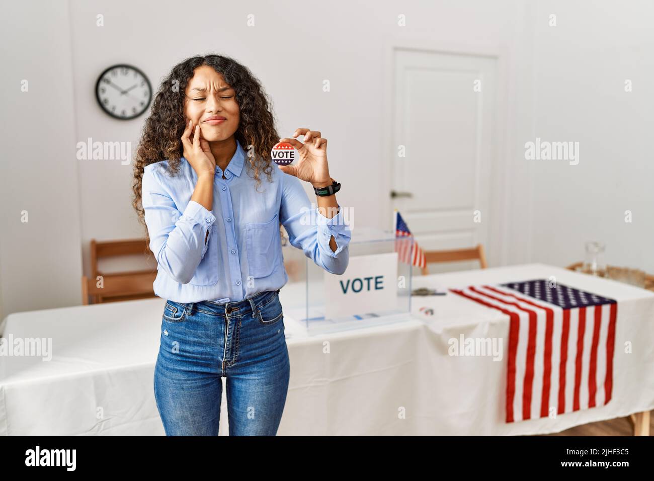 Beautiful hispanic woman standing by at political campaign by voting ...