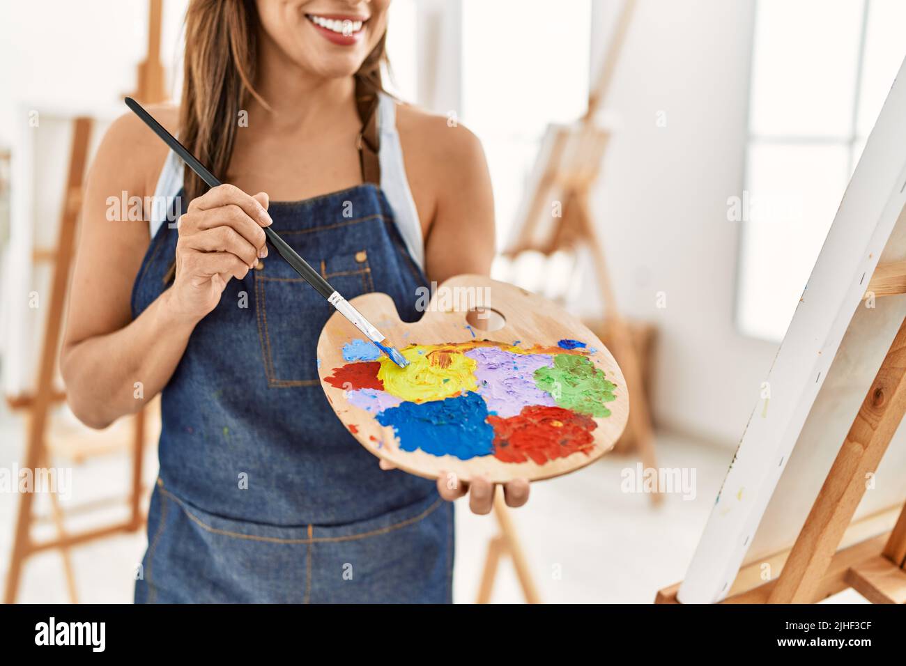 Young hispanic artist woman smiling happy drawing at art studio Stock ...