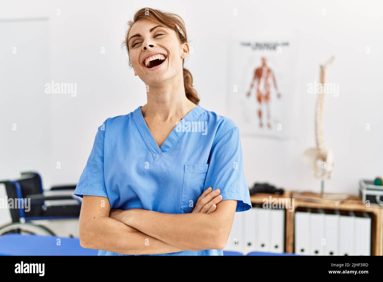 Young caucasian physio therapist girl standing with arms crossed ...
