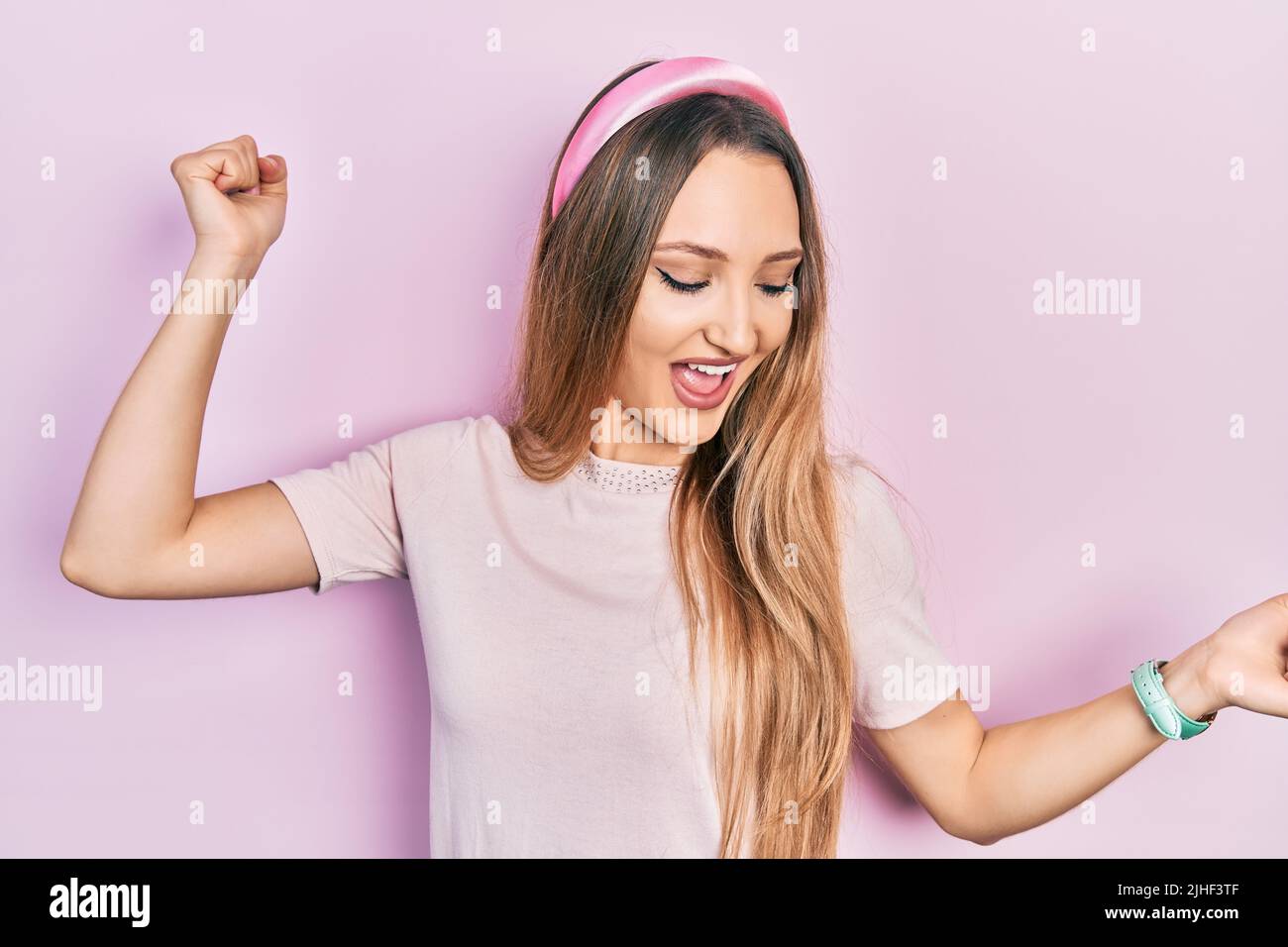 Young blonde girl wearing casual clothes dancing happy and cheerful ...