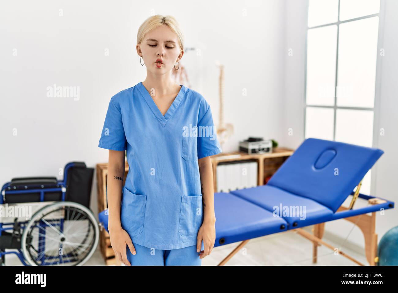 Beautiful caucasian physiotherapist woman working at pain recovery ...