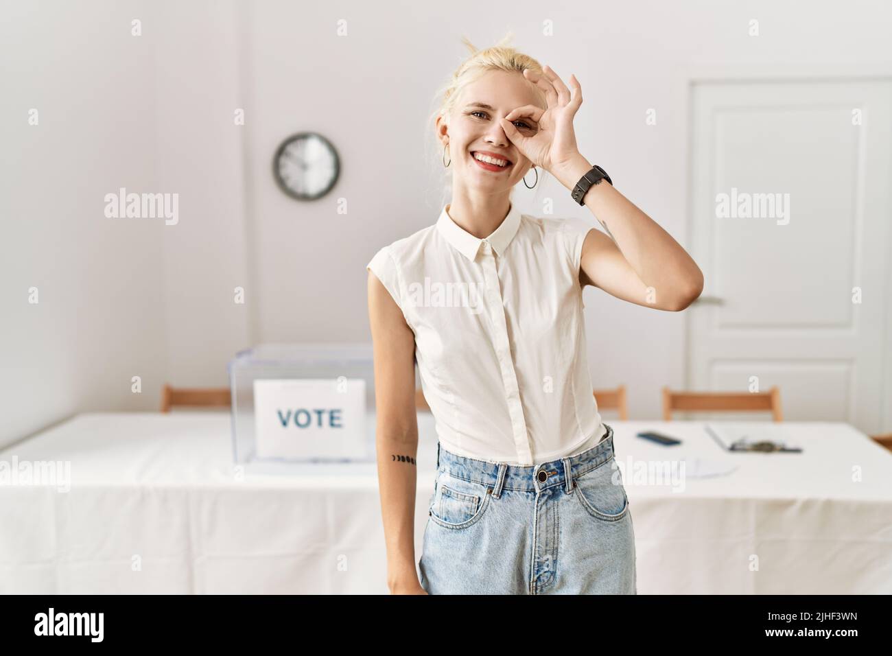 Beautiful caucasian woman standing by voting ballot at election room ...