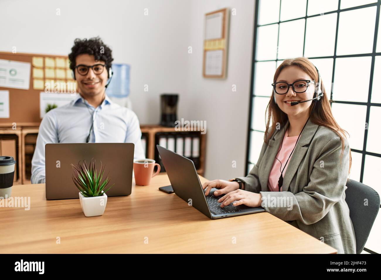Two call center agent smiling happy working at the office Stock Photo ...