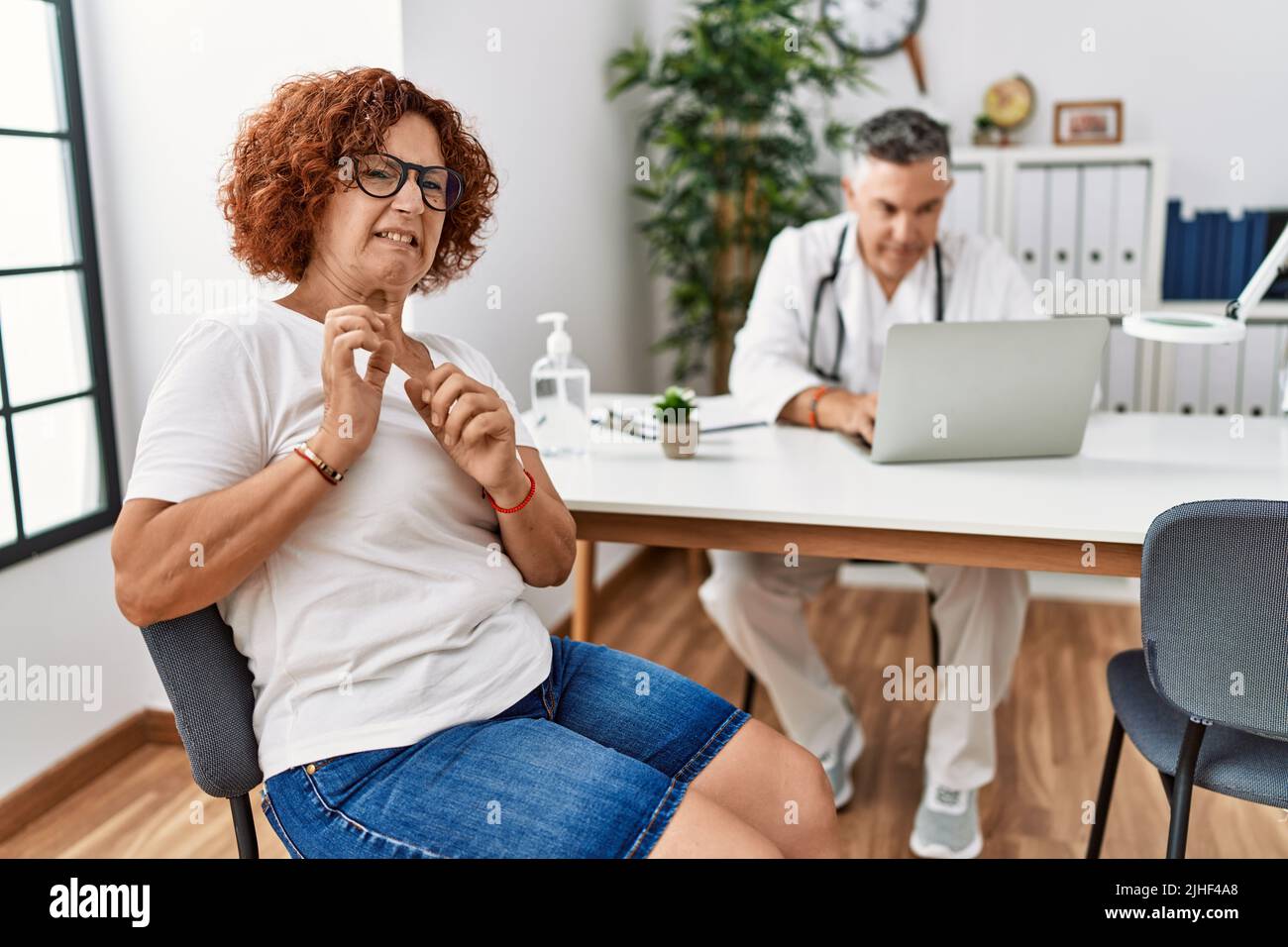 Senior woman sitting at doctor appointment disgusted expression ...