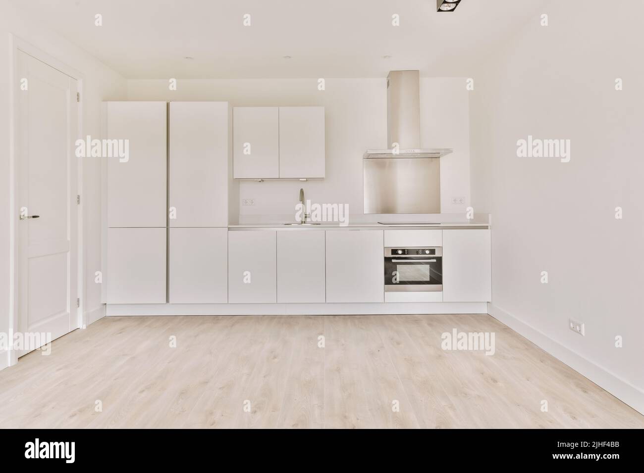 Interior of empty white kitchen with windows and wooden parquet floor ...