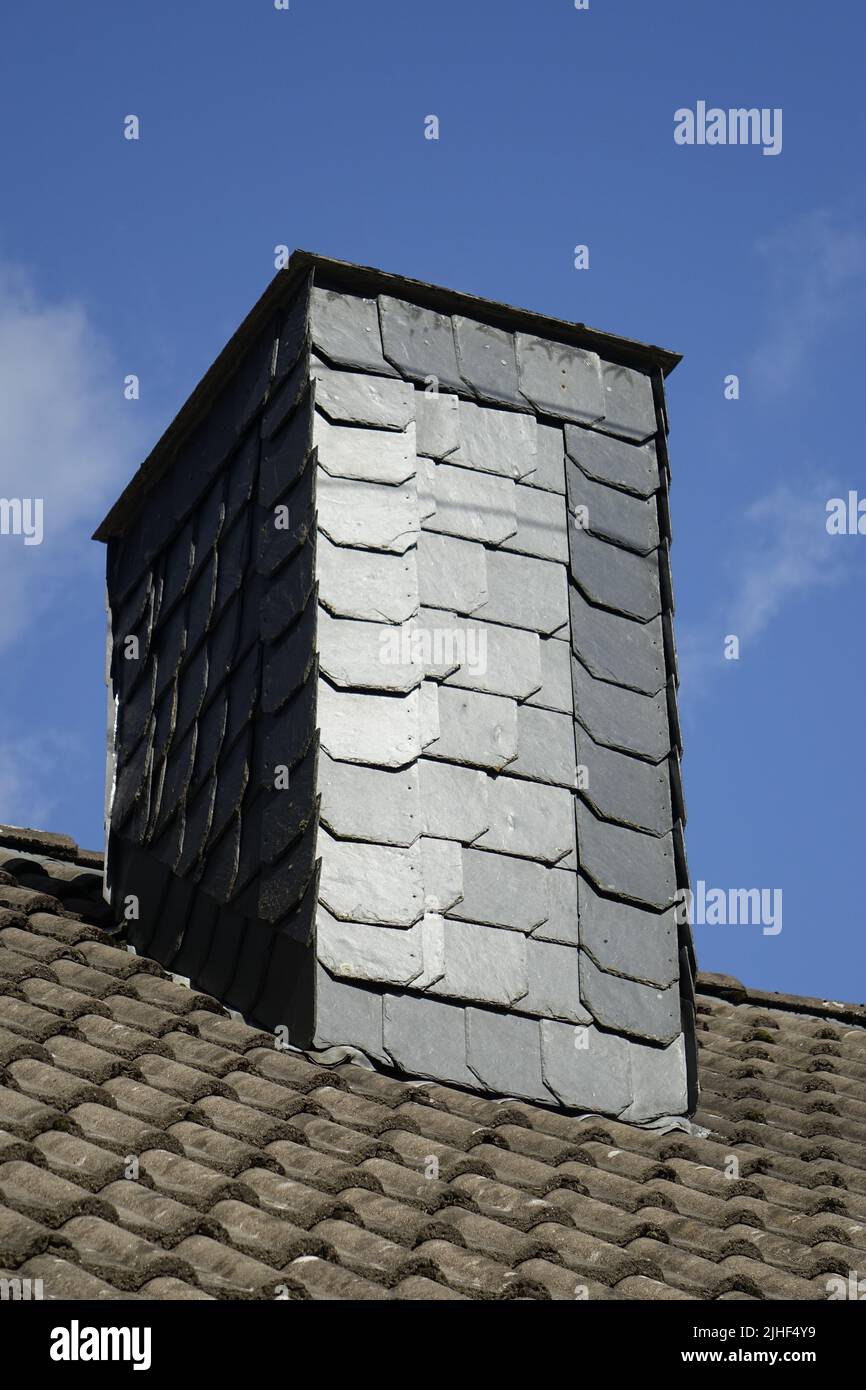 The vertical view of a gray chimney on the rooftop Stock Photo - Alamy