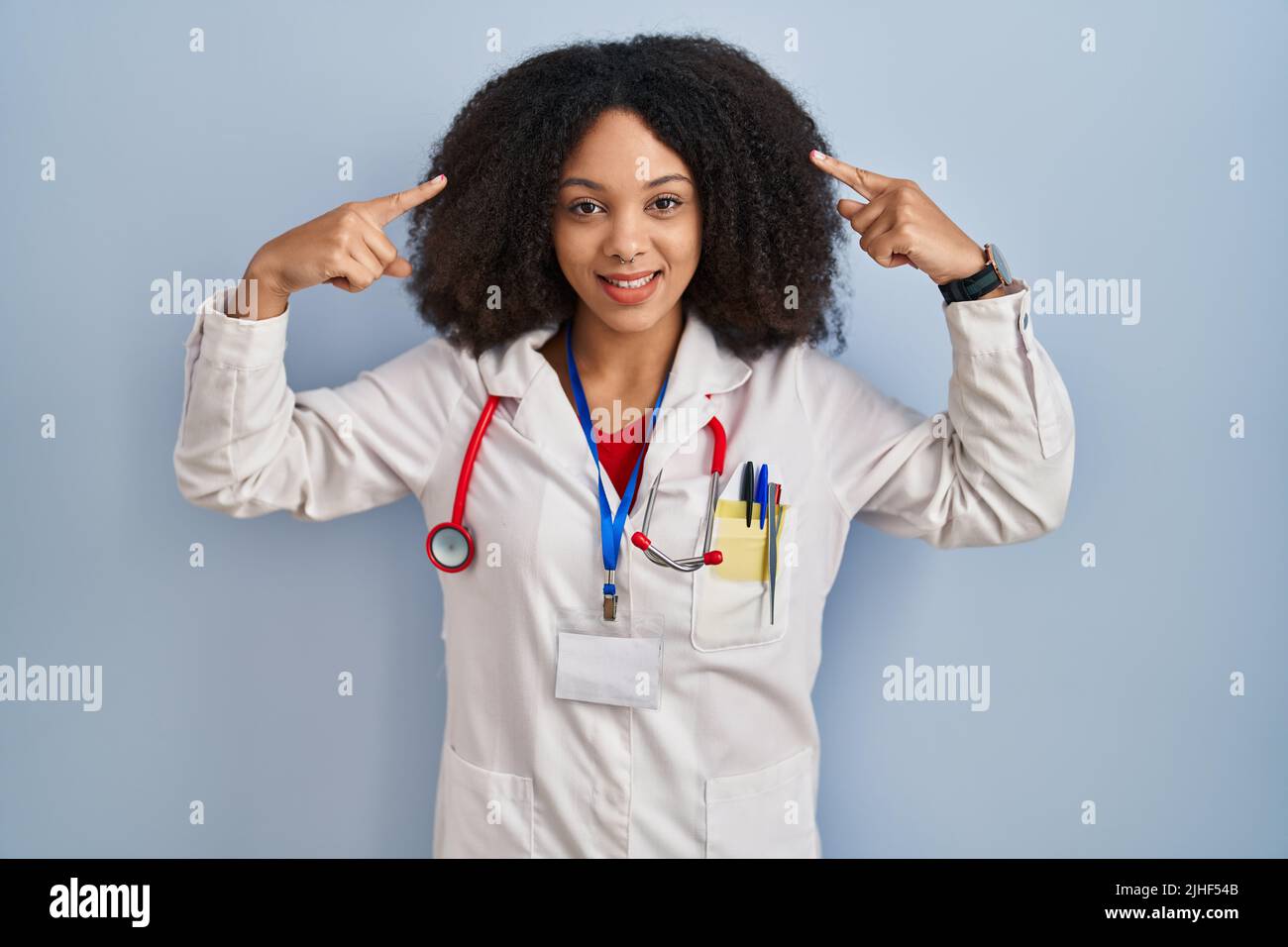 Young african american woman wearing doctor uniform and stethoscope ...