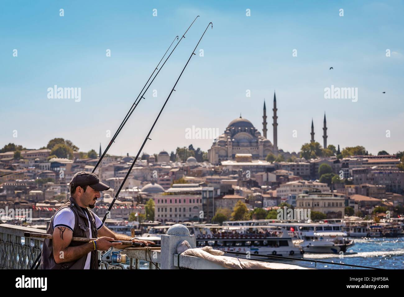 A fisherman at the Galata Bridge in Istanbul, Turkey Stock Photo - Alamy