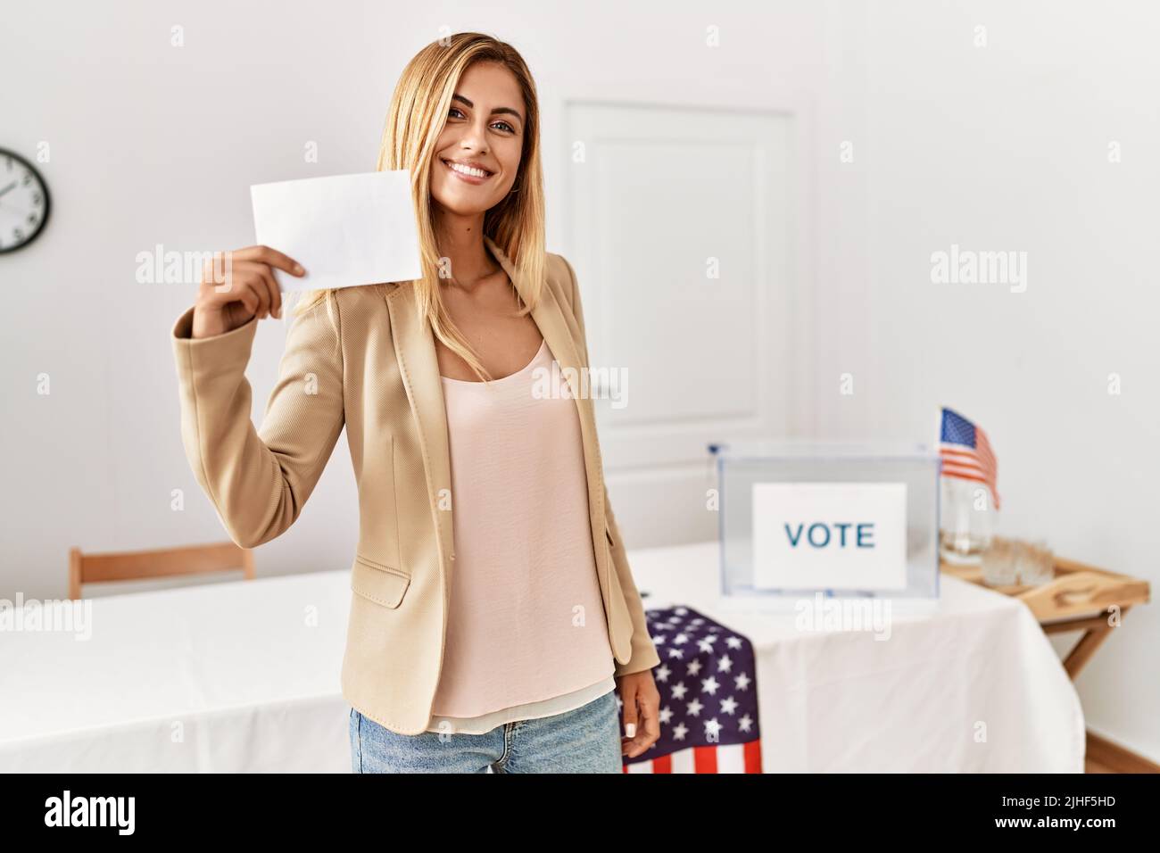 Young american voter woman smiling happy holding vote at electoral ...