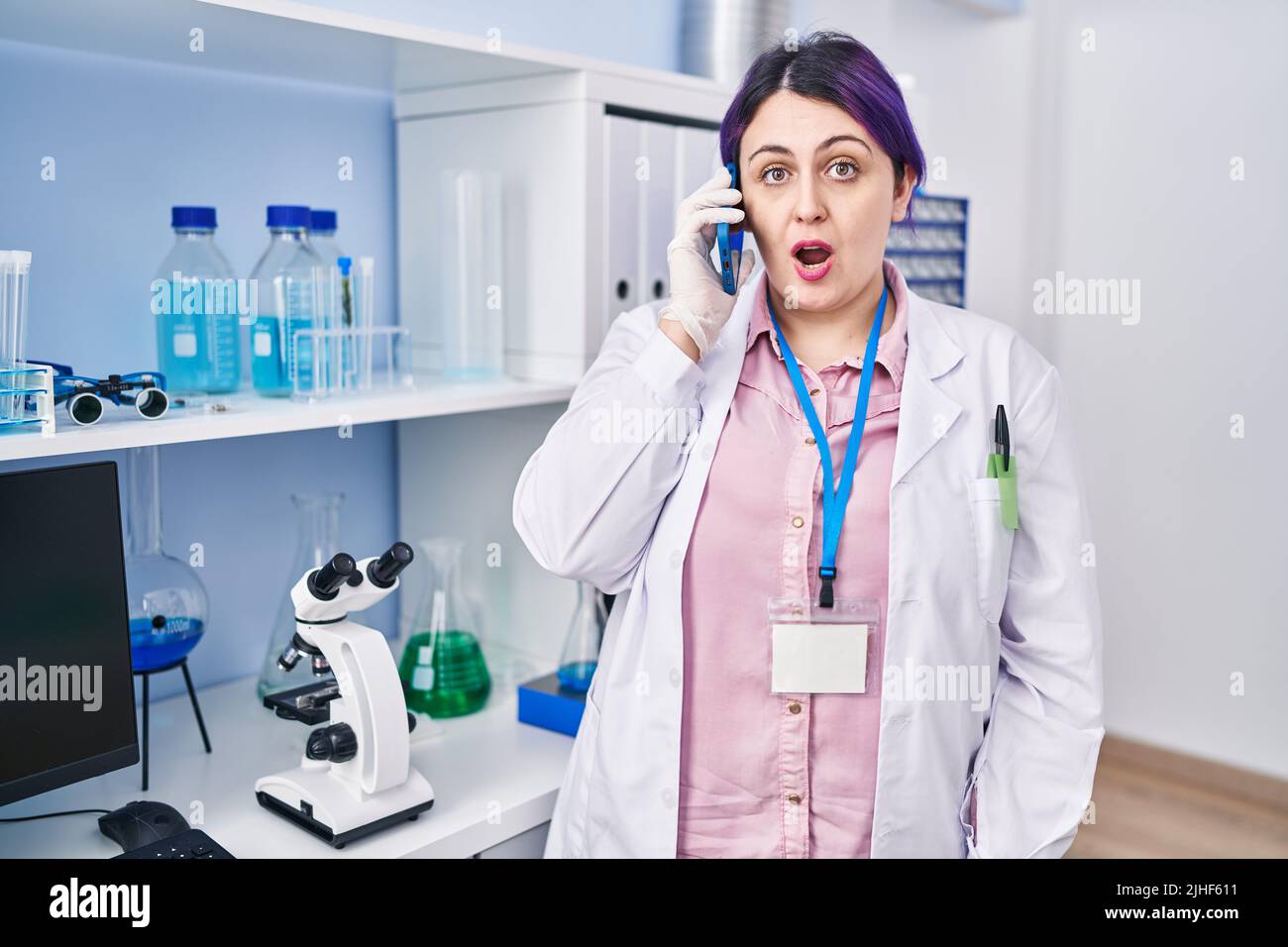 Plus size woman wit purple hair working at scientist laboratory ...