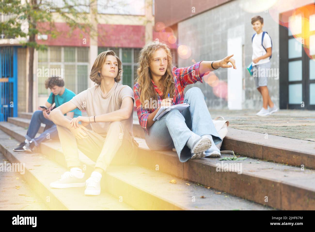 Teenagers sitting on stairs beside school Stock Photo - Alamy