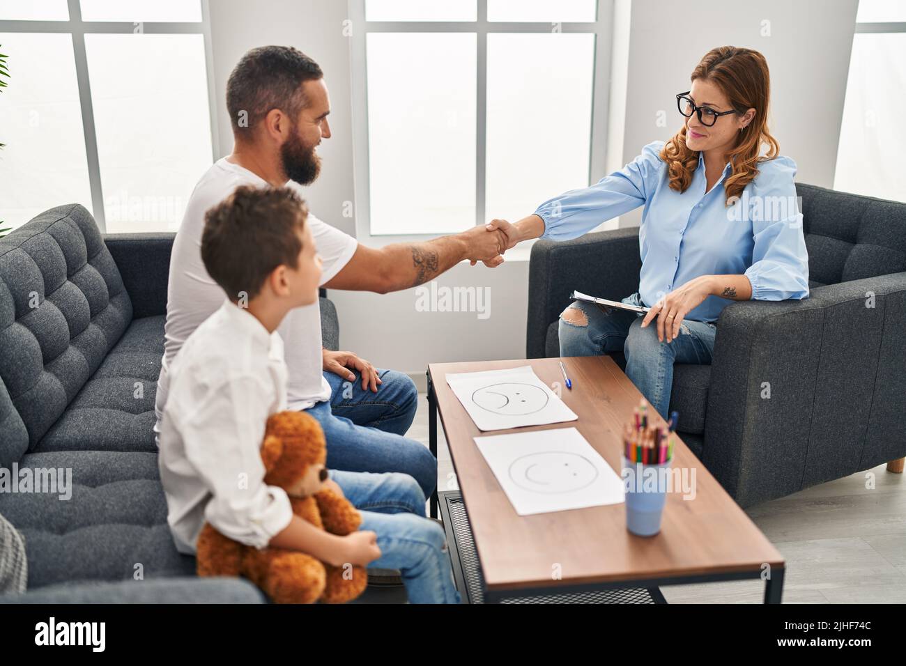 Family having psychology session shake hands at psychology center Stock ...