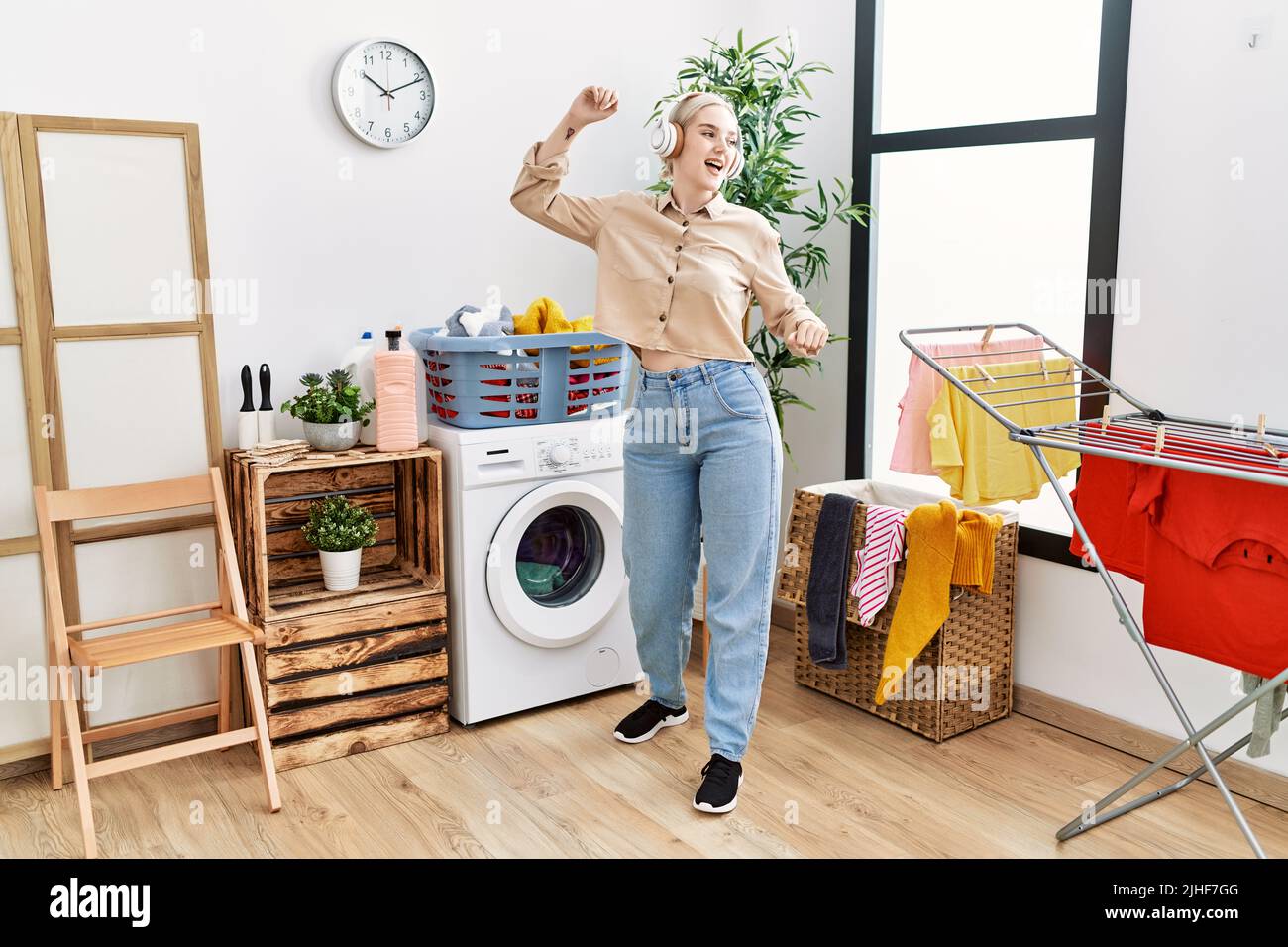 Young caucasian woman smiling confident dancing at laundry room Stock ...