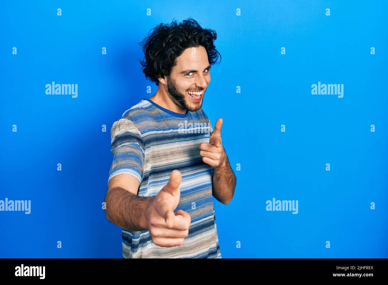 Handsome hispanic man wearing casual clothes over pink background ...