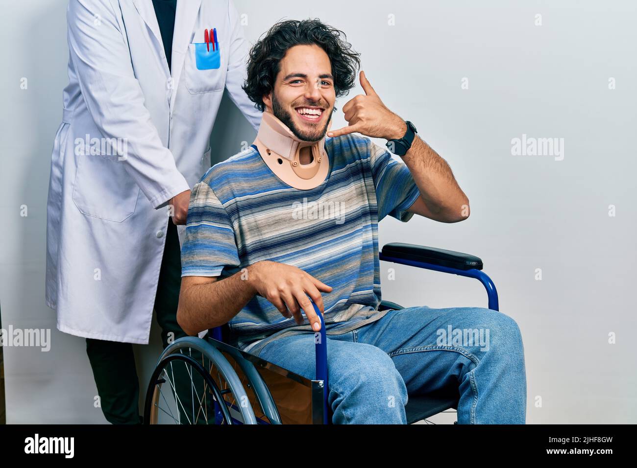 Handsome hispanic man sitting on wheelchair wearing neck collar smiling ...