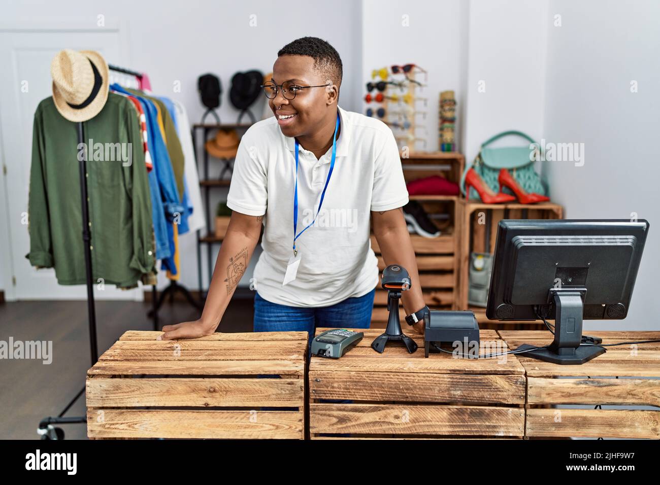 Young african man working as shop assistance at retail shop Stock Photo ...