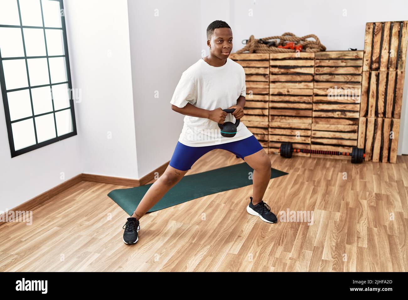 Young african man training with dumbbells at the gym Stock Photo - Alamy