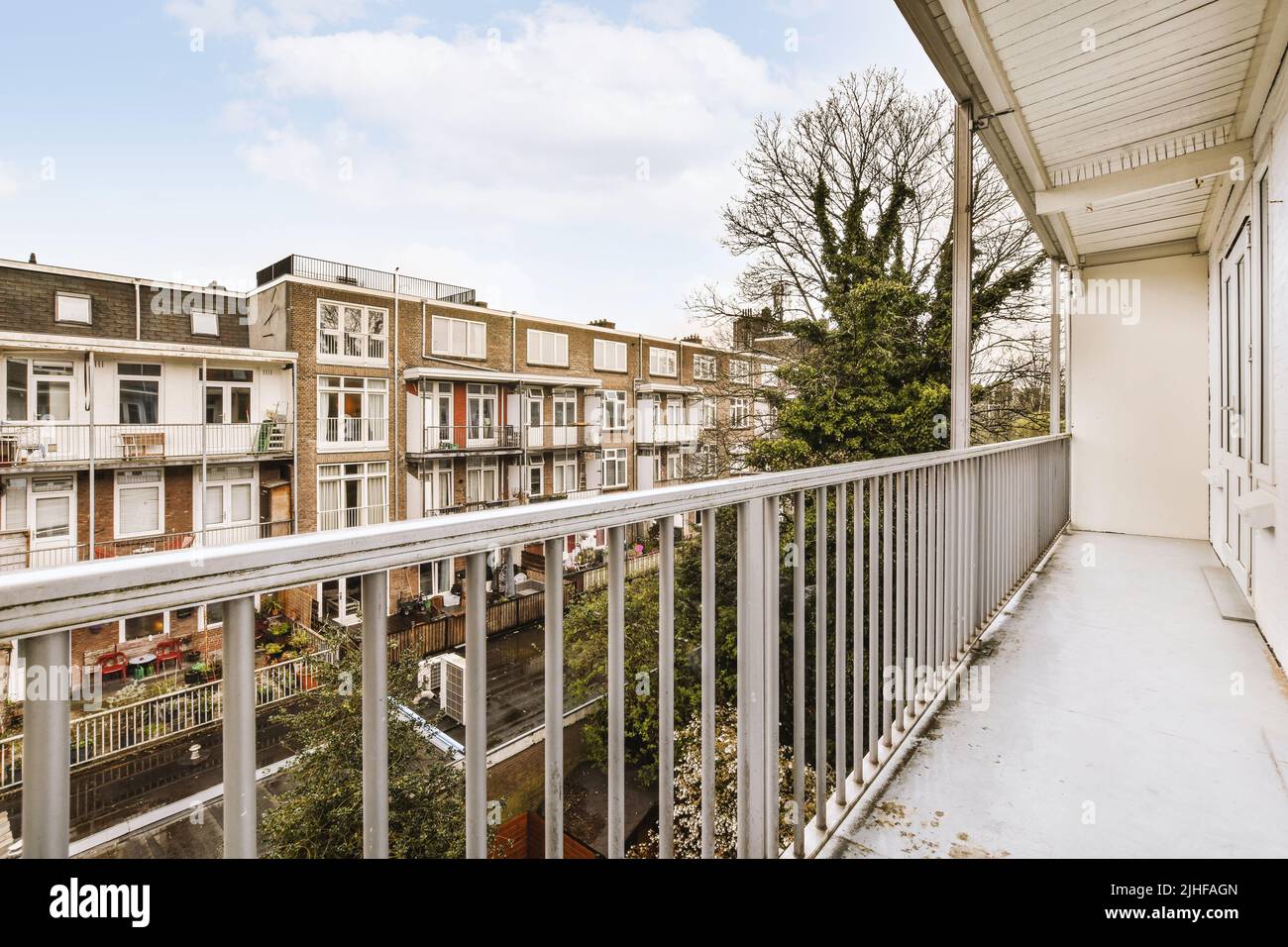 Front view of old brick buildings and cars with bicycles from small ...