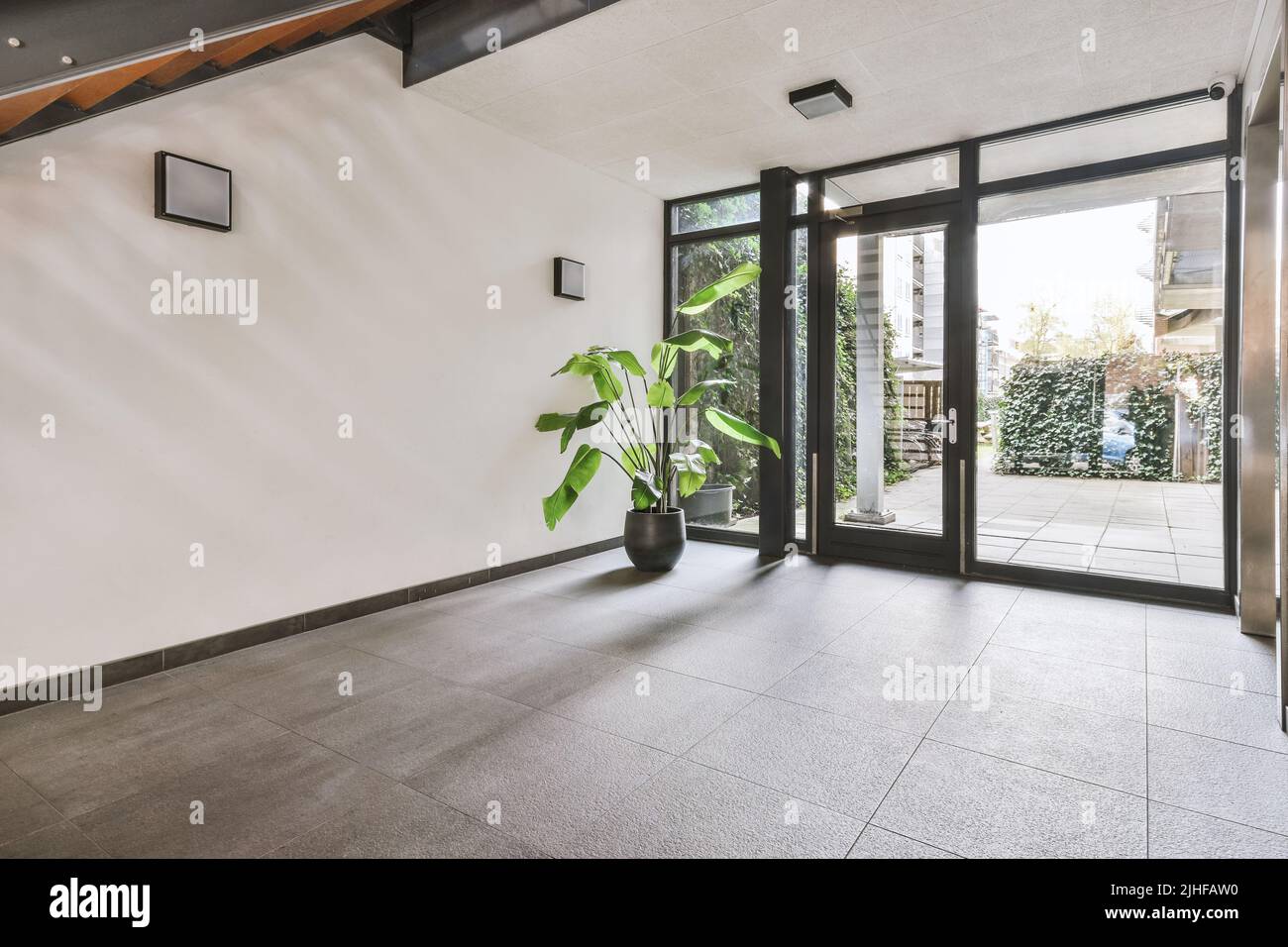 Perspective view of empty narrow hallway with white walls parquet floor ...