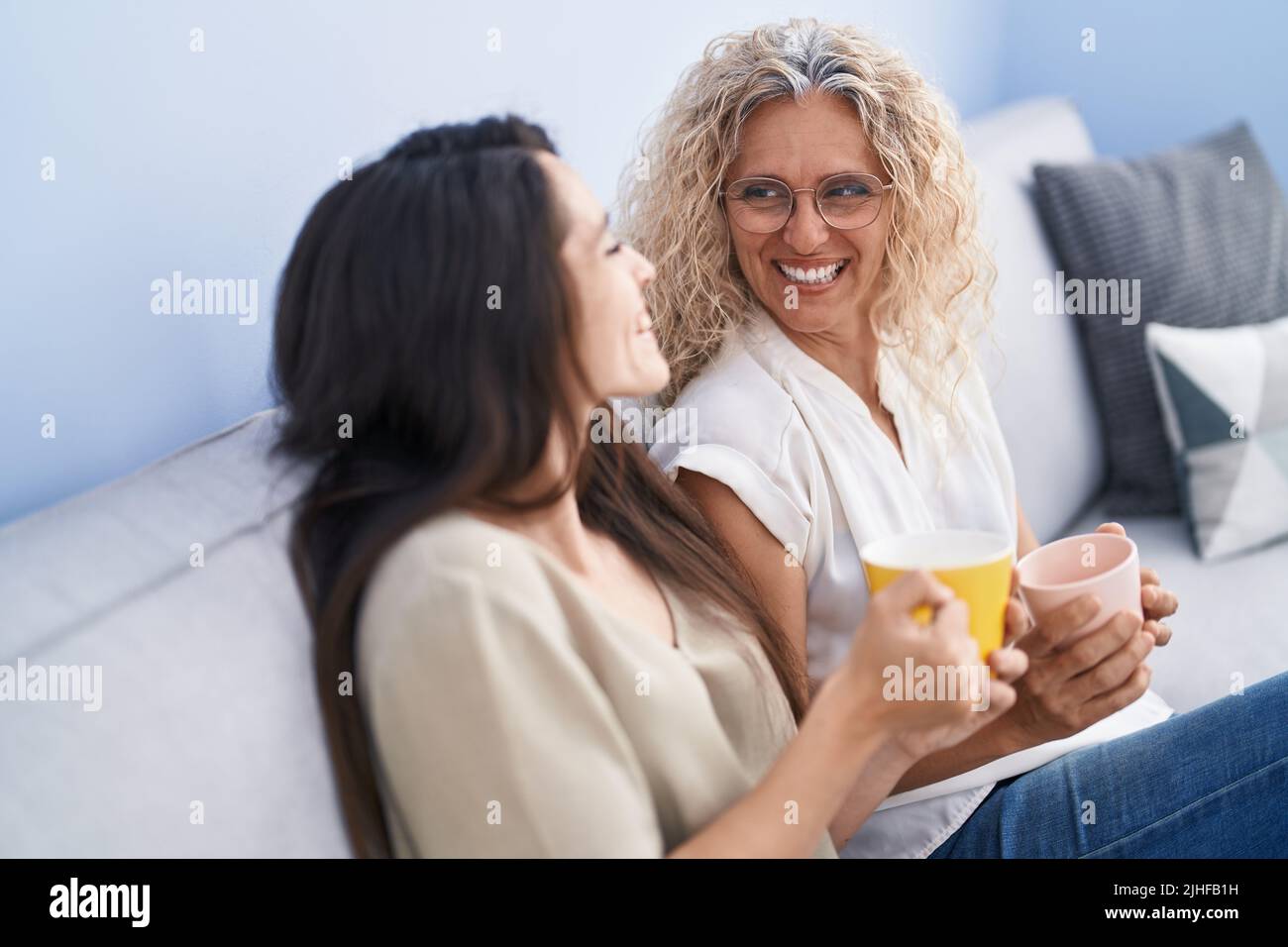 Two women mother and daughter drinking coffee at home Stock Photo - Alamy