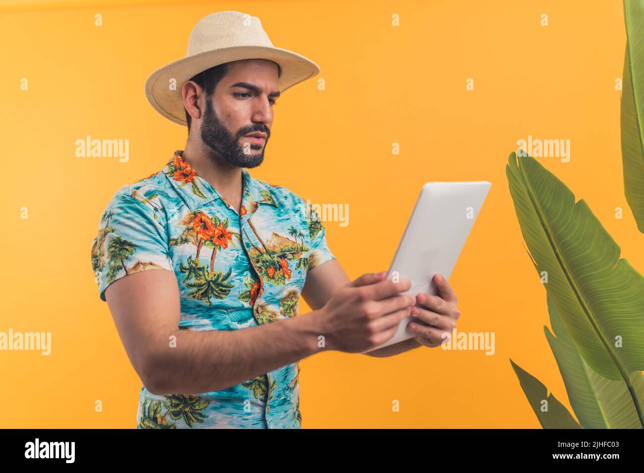 medium portrait of a young man standing while searching something in ...