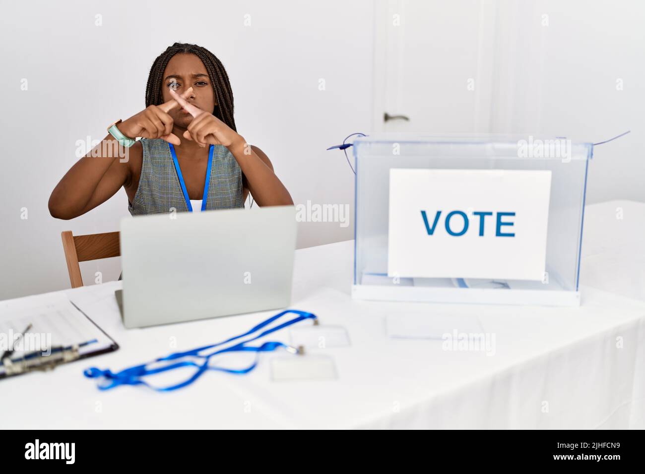 Young african american woman working at political election sitting by ...