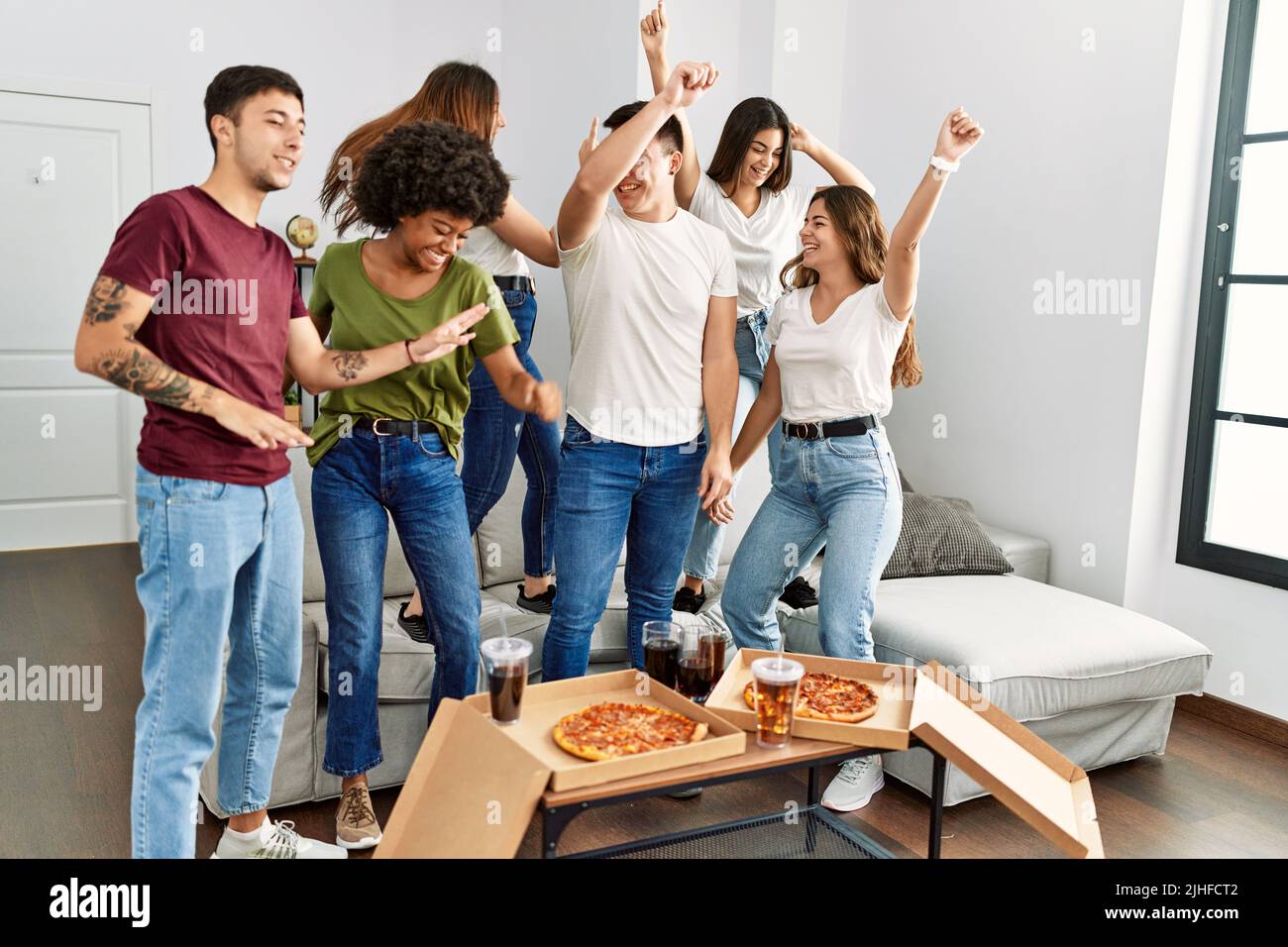 Group of young friends having party eating italian pizza and and ...
