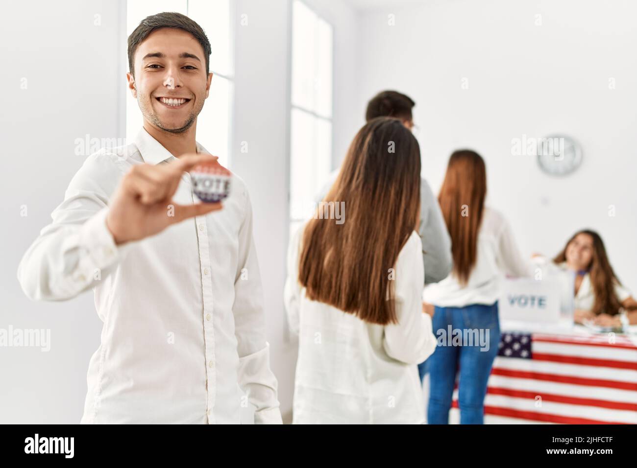 Group of young american voter people putting vote in ballot. Man ...