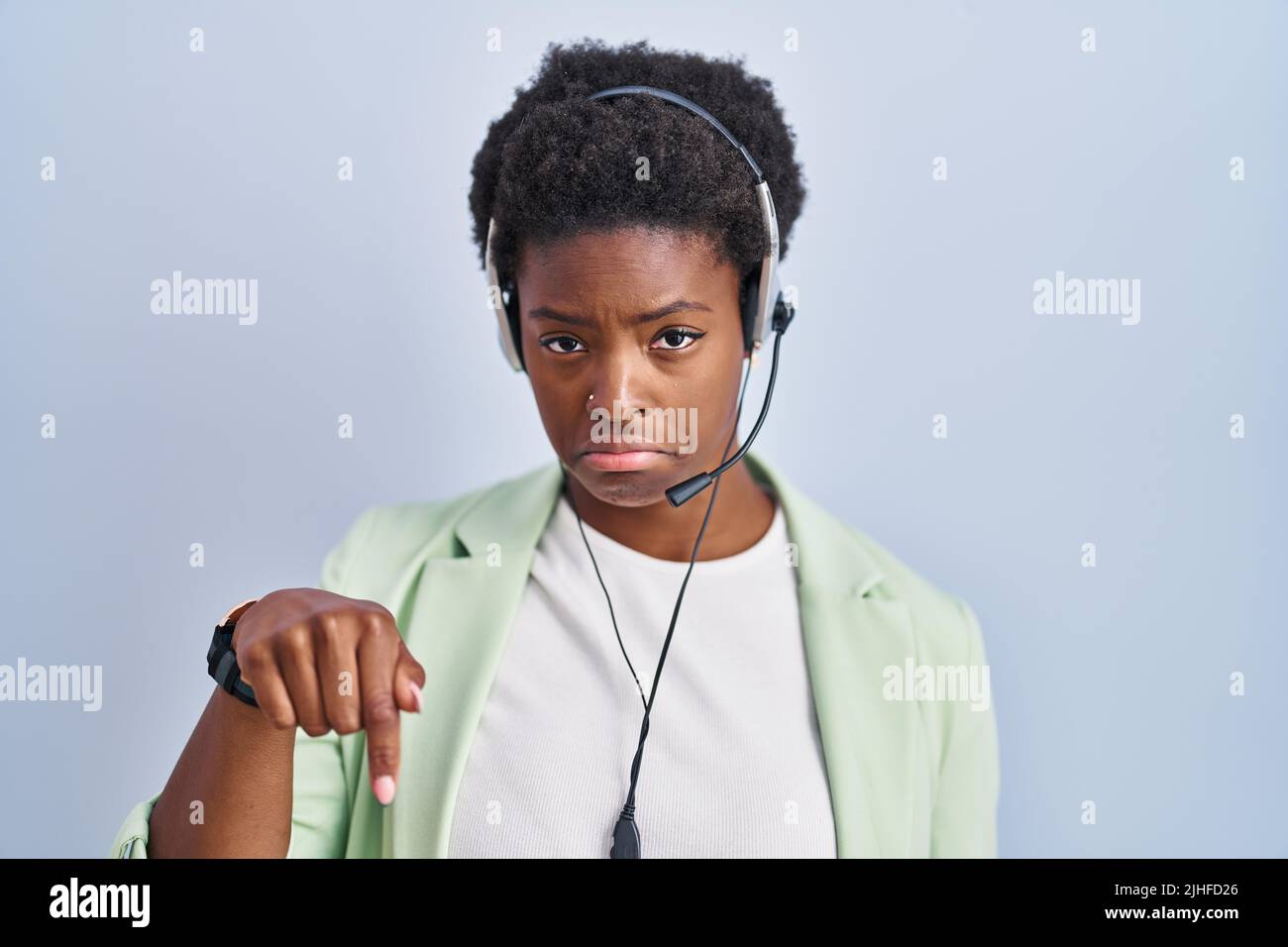 African american woman wearing call center agent headset pointing down ...