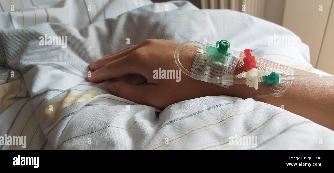 Overview of a hand with a cannula with band aid and tube Stock Photo ...