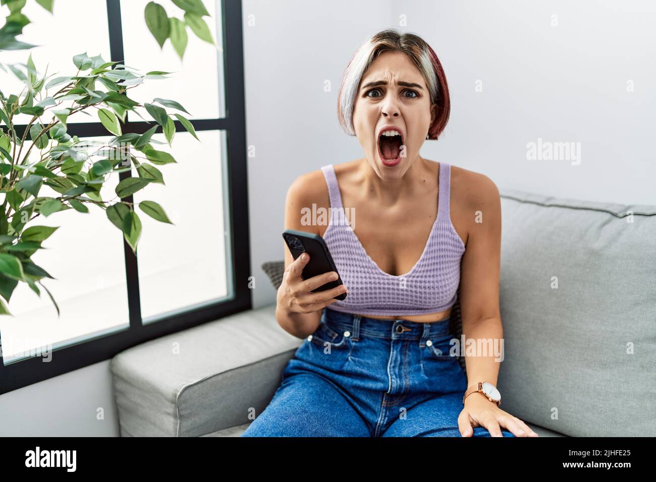 Young beautiful woman using smartphone typing message sitting on the ...