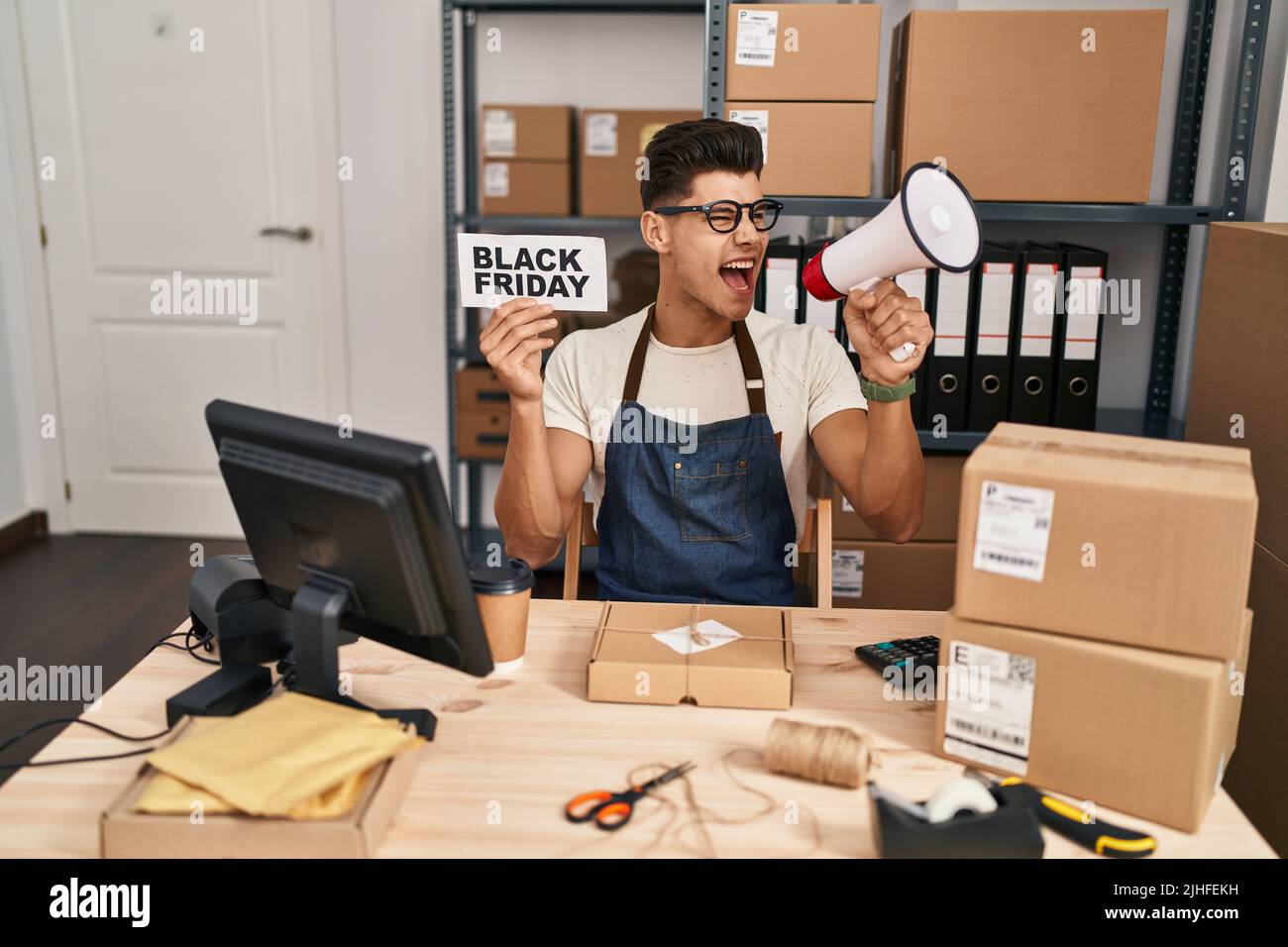 Young hispanic man holding black friday banner small commerce angry and ...