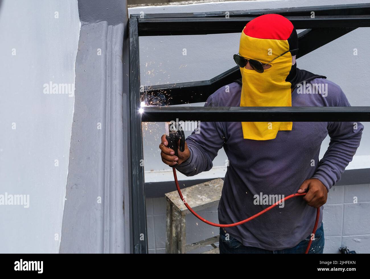The welder is welding the steel structure to add to the house Stock ...