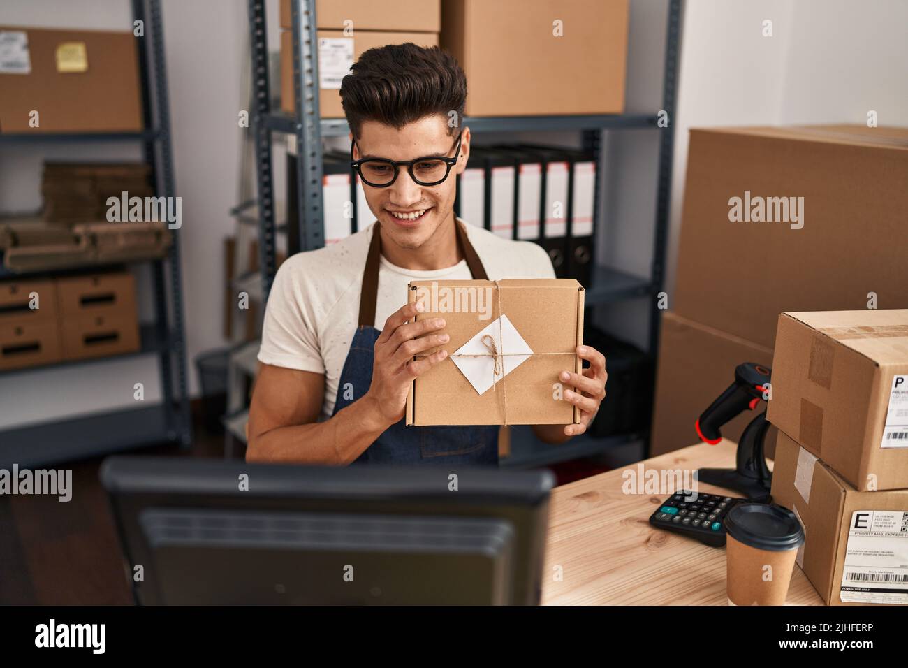 Young hispanic man ecommerce business worker having video call showing ...