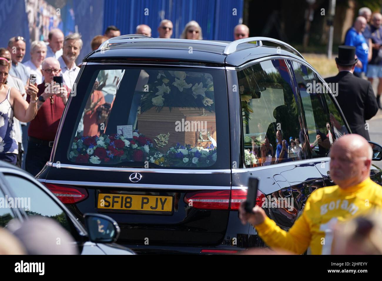 The crowd outside Ibrox Stadium watch the passing cortege ahead of the ...