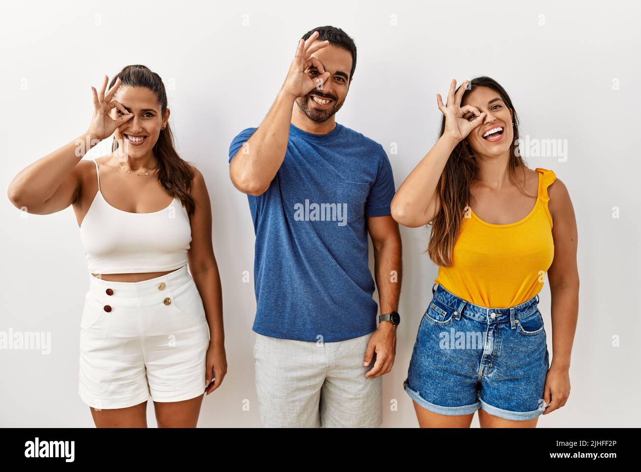 Group of young hispanic people standing over isolated background doing ...