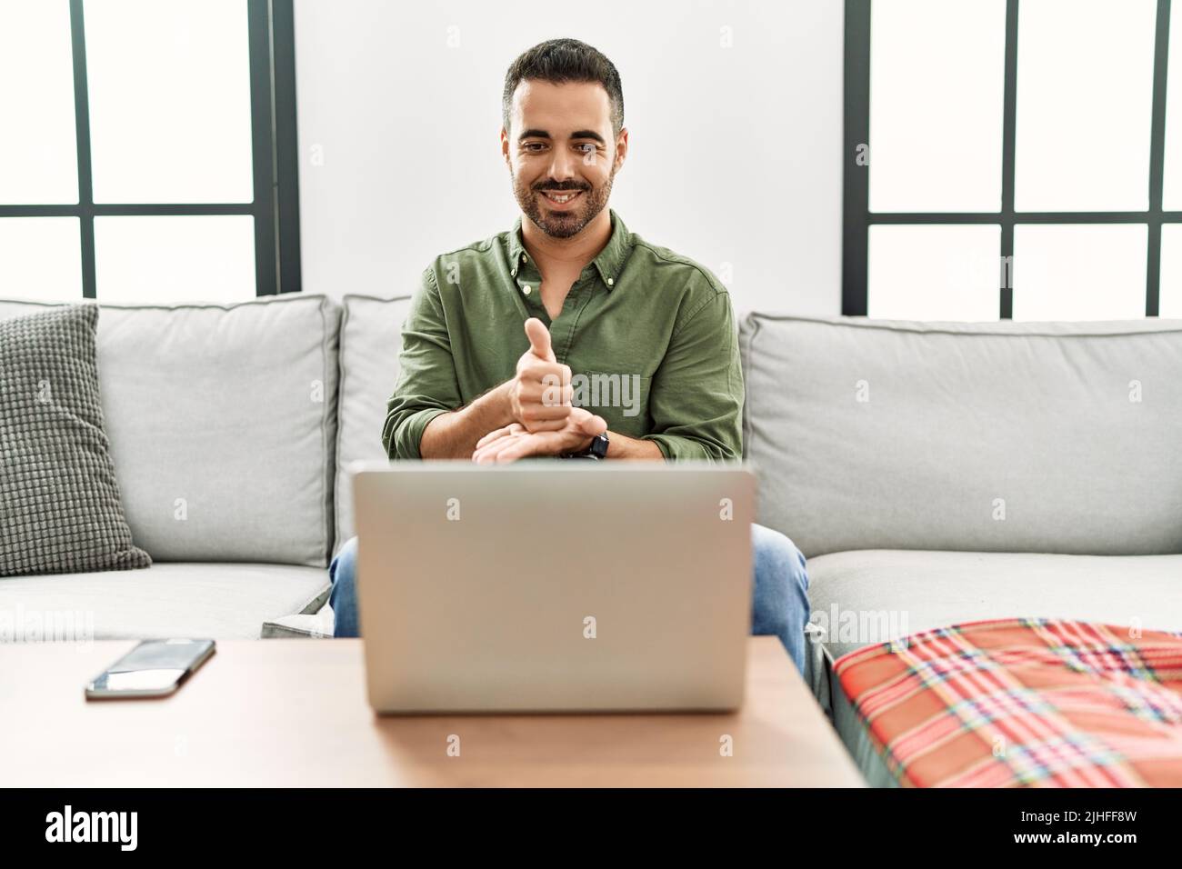Young hispanic man having video call speaking with deaf language at ...