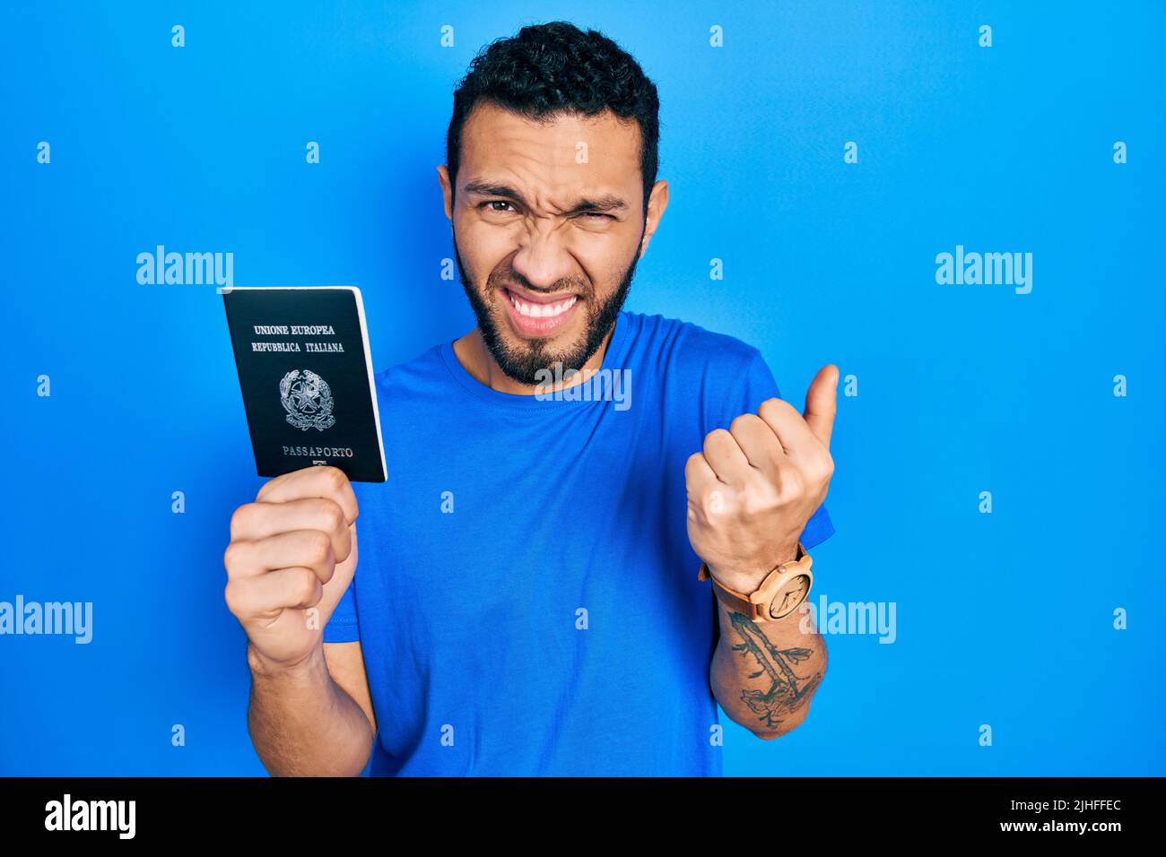 Hispanic man with beard holding italy passport angry and mad raising ...
