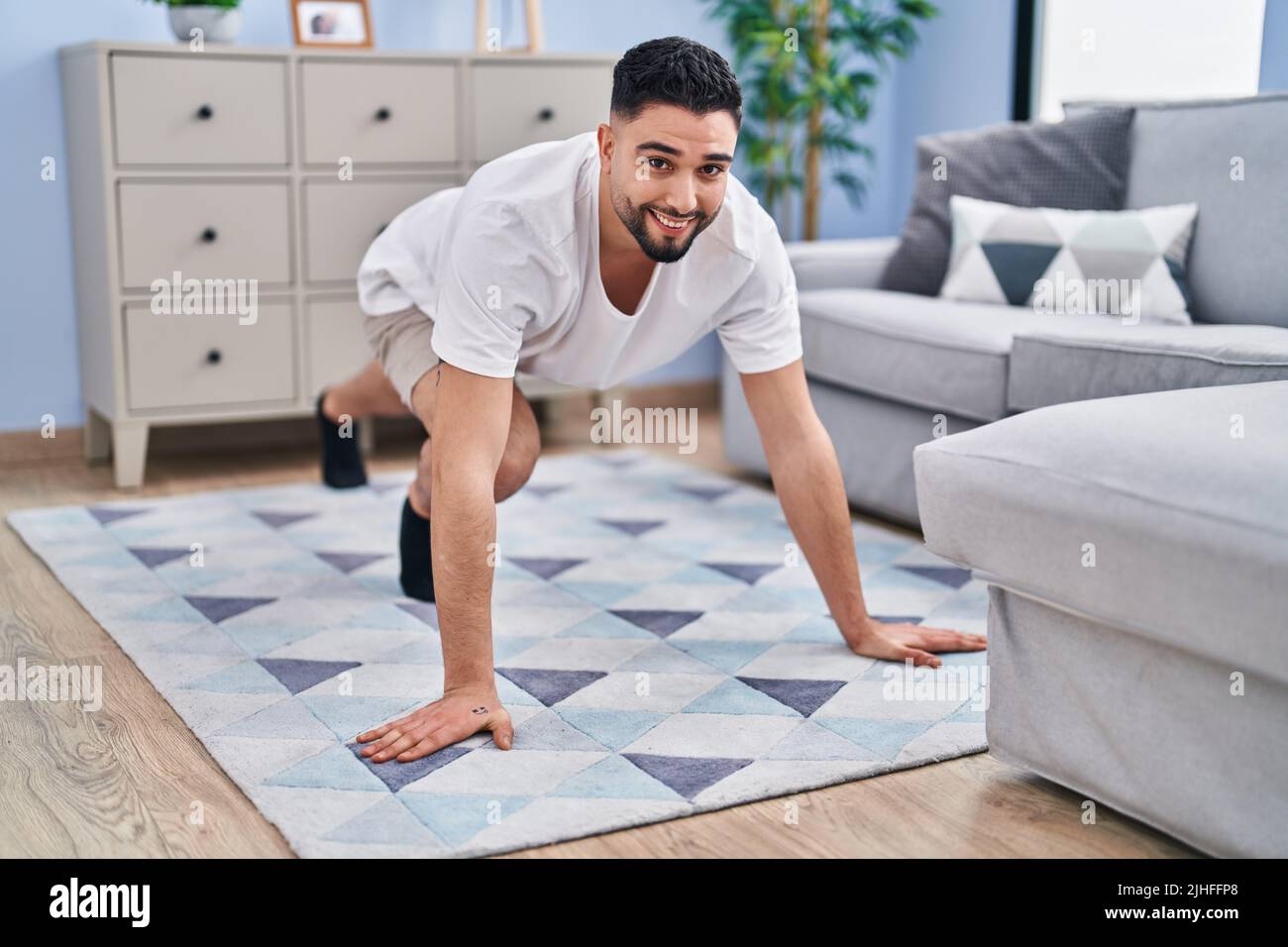 Young arab man smiling confident training abs exercise at home Stock ...