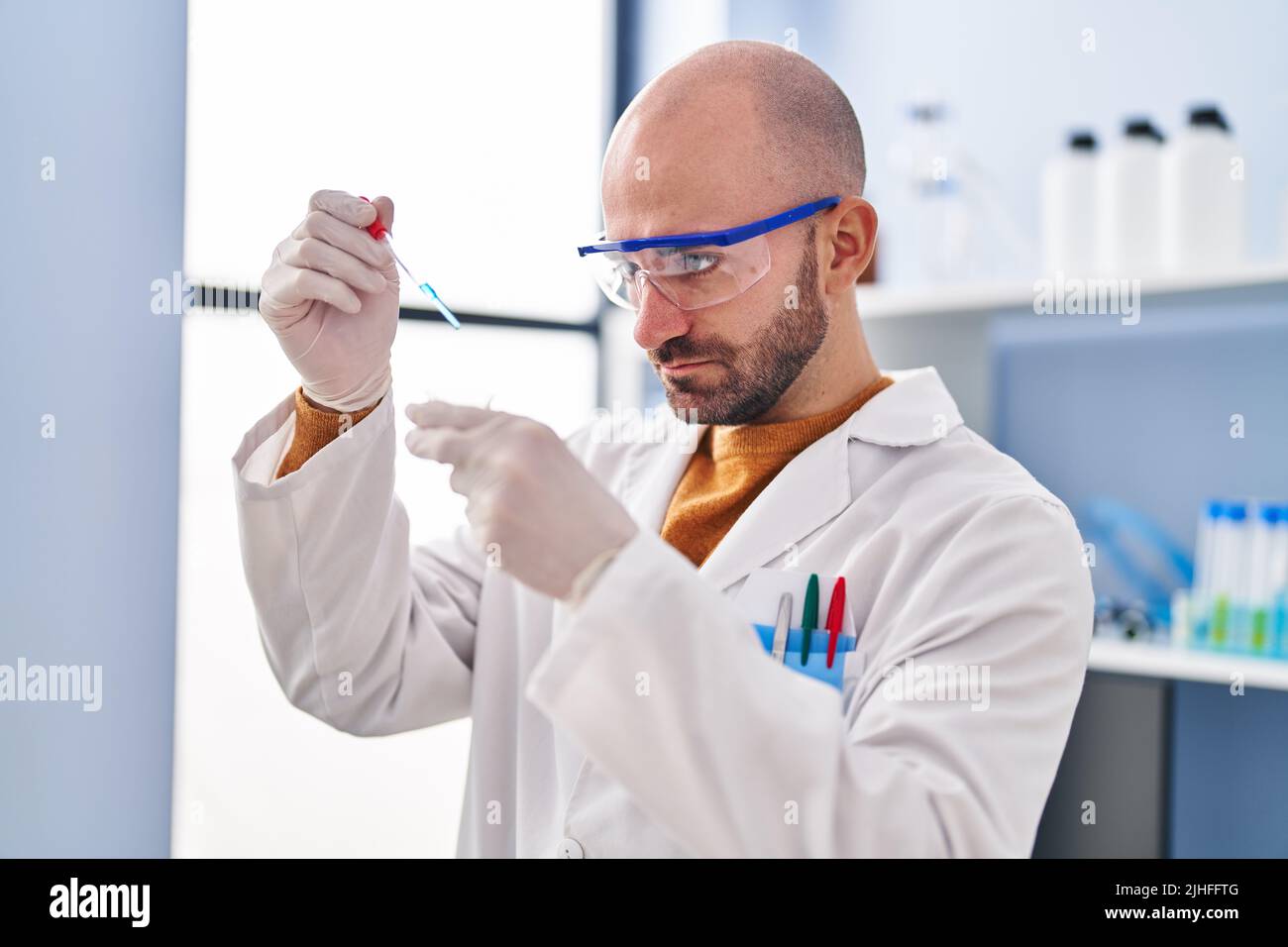 Young man scientist measuring liquid at laboratory Stock Photo - Alamy