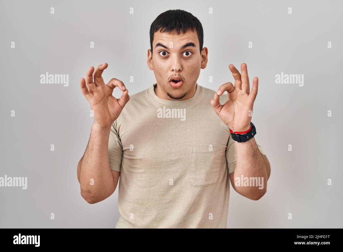 Young arab man wearing casual t shirt looking surprised and shocked ...