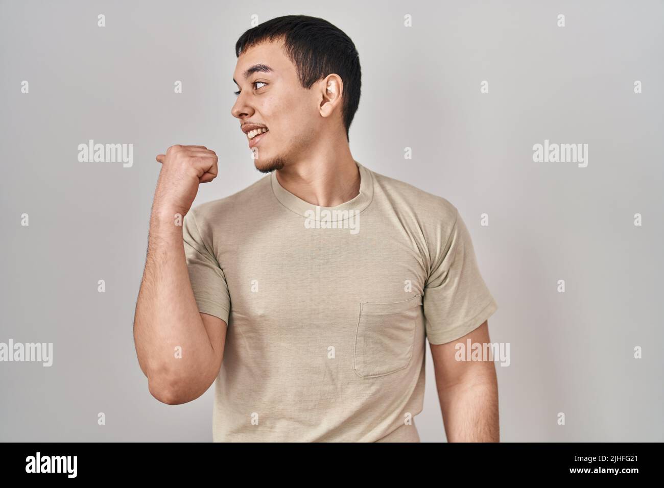 Young arab man wearing casual t shirt smiling with happy face looking ...
