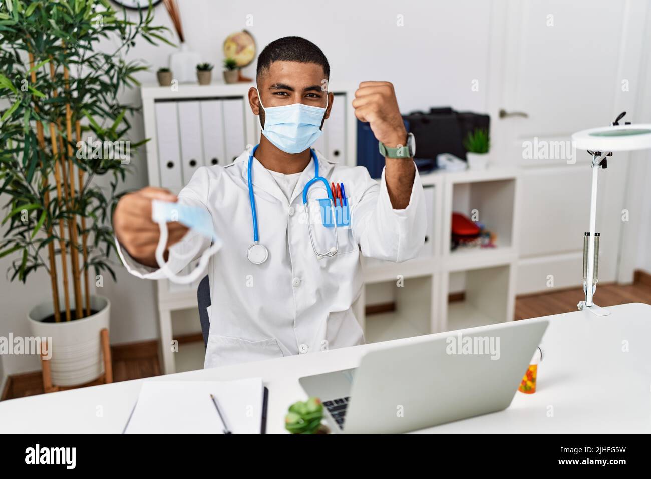 Young indian doctor offering safety mask annoyed and frustrated ...