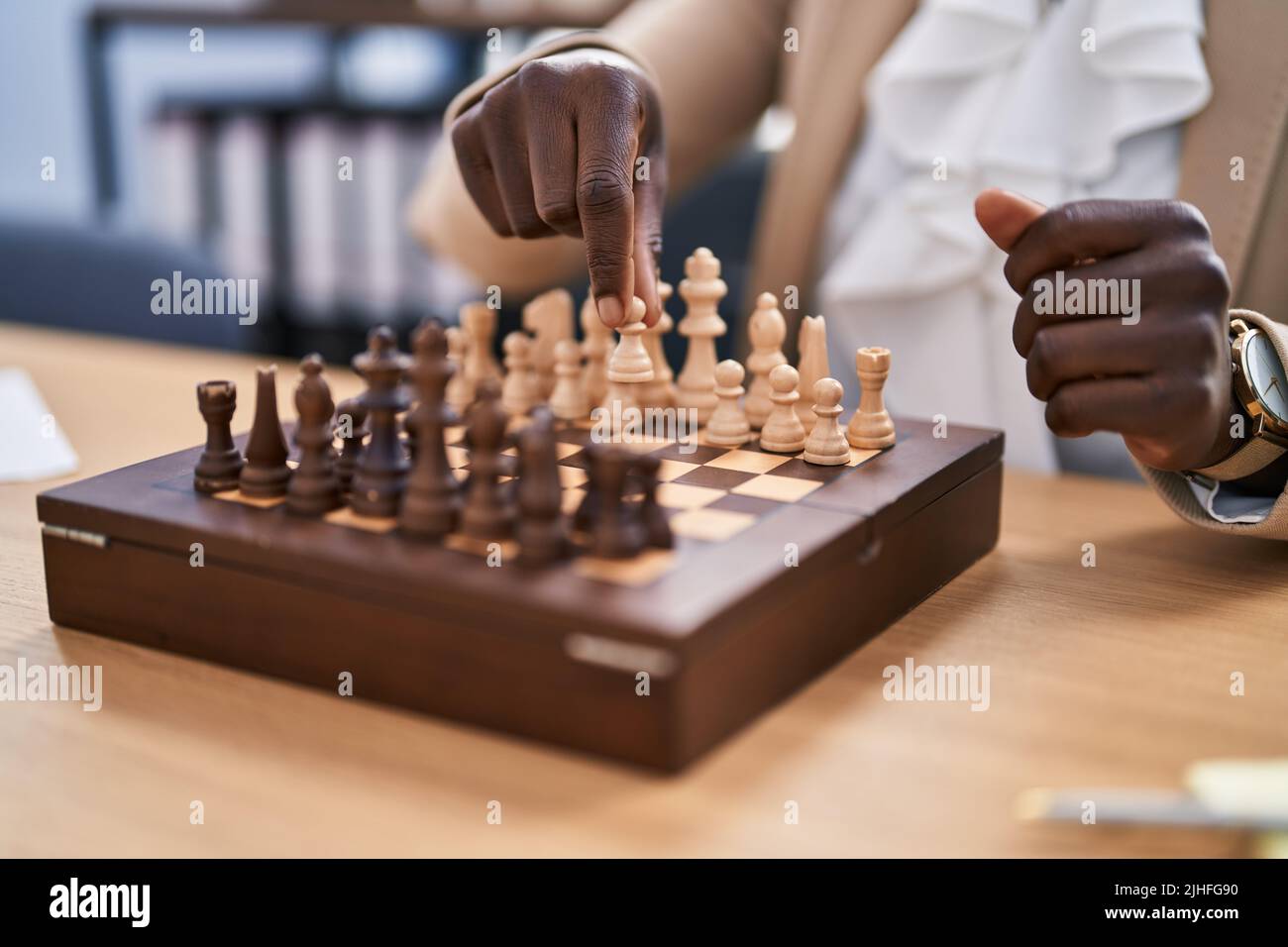 Young african american woman playing chess at home Stock Photo - Alamy