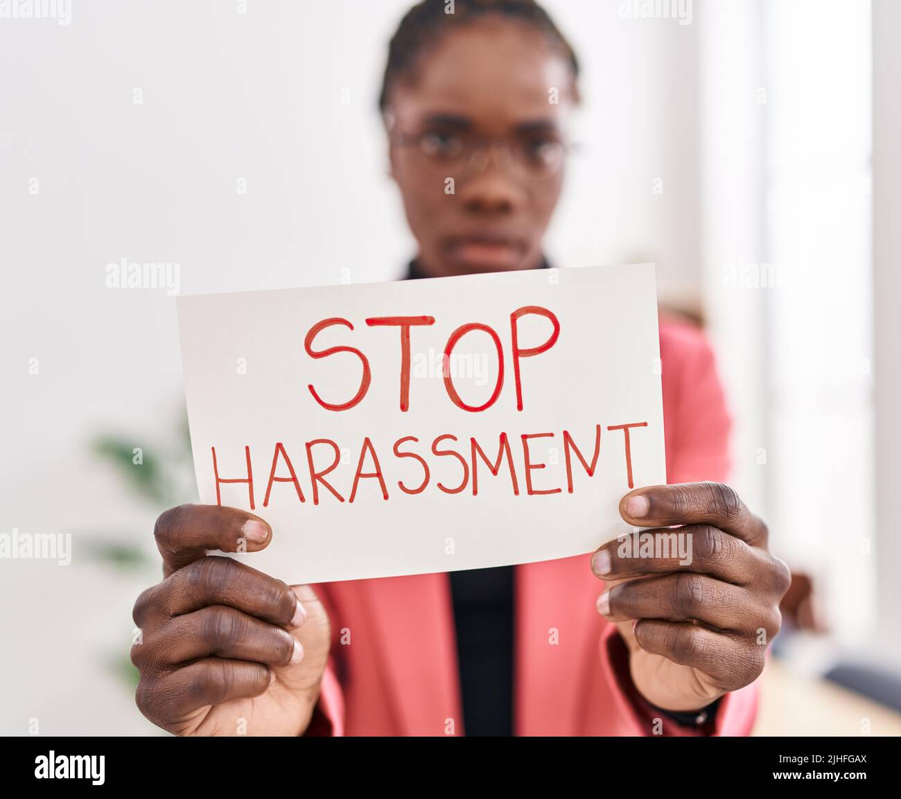 African american woman business worker holding stop harassement banner ...