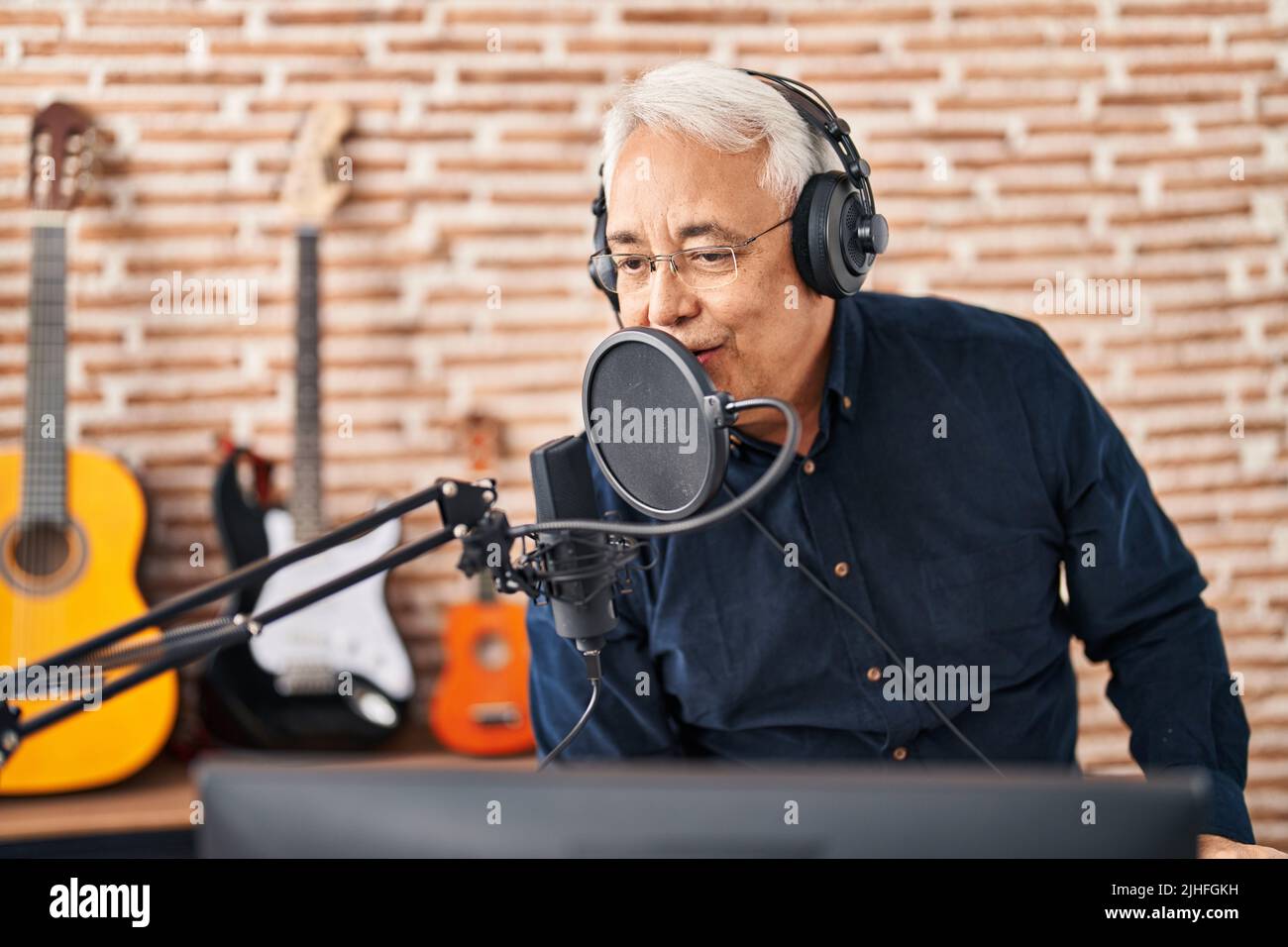 Senior man artist singing song at music studio Stock Photo - Alamy